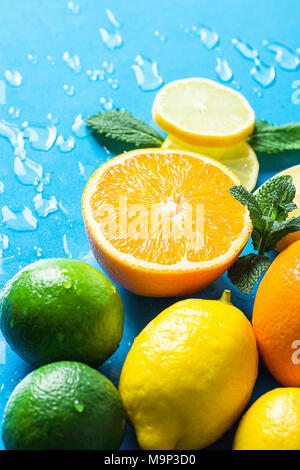 Whole and halved lemons on light yellow backdrop Stock Photo - Alamy
