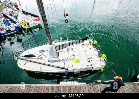 Two men are lifting the SEAir Mini 747 to the water with a crane. The 6 ...