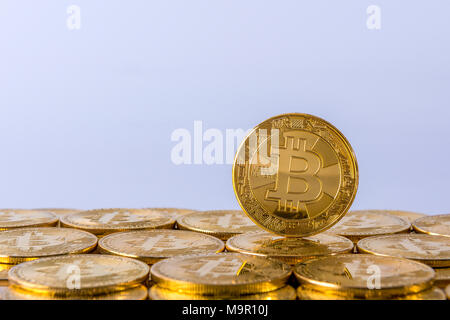 Golden bitcoin in a pile of coins on the background of Citigroup logo ...