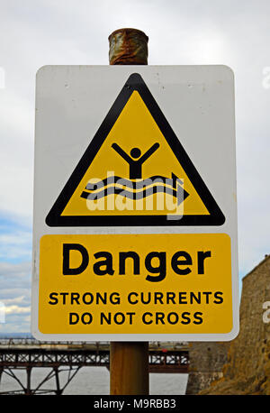 A sign warning of strong currents with Birnbeck Pier, Weston-super-Mare ...