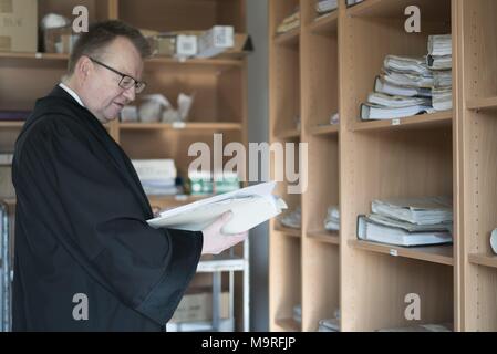 Judge reading a court file at Bielefeld district court, 15.3.2018 ...