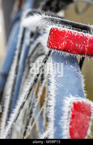 Bicycle on ice. Close-up of a studded bicycle tire on the background of ...