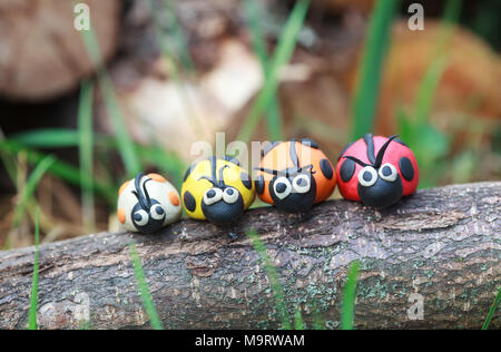 Plasticine world - four little homemade colorful ladybirds sitting on a ...