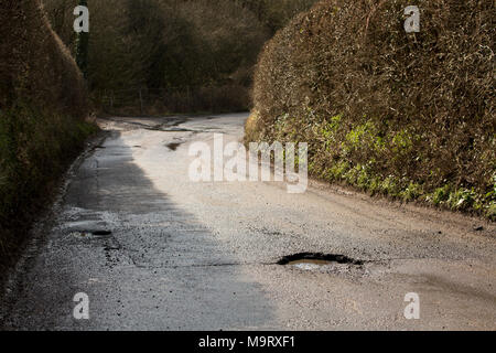 Potholes in a country lane Stock Photo - Alamy