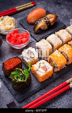 Sushi and ingredients on dark background Stock Photo - Alamy