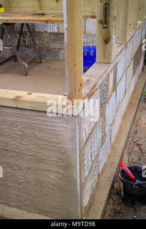 Part constructed garden workshop using reclaimed concrete blocks and ...