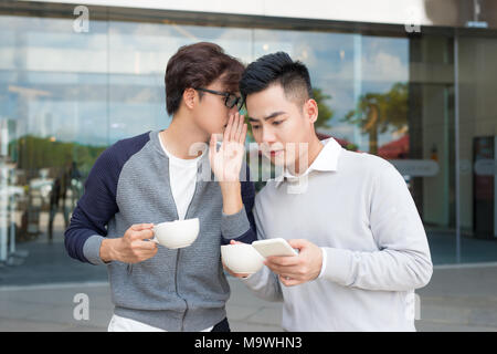 Closeup portrait guy whispering into man's ear telling him something ...