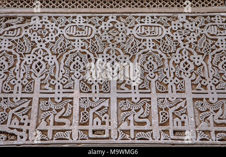 Traditional ornate plaster work and mosaic tiles with carved wooden ...