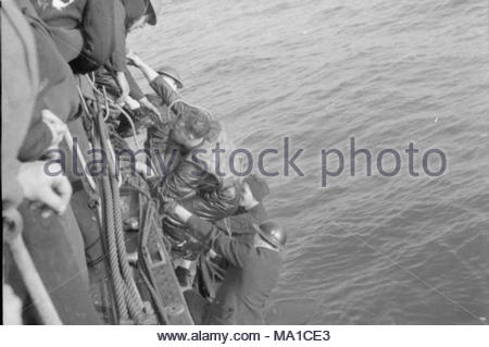 DIEPPE RAID - August 1942. A British Commando at right gives a Stock ...