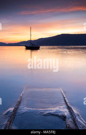 Emerged boat rails at Sasso Moro dock during an autumnal sunset, Sasso ...