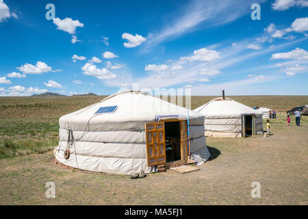 Mongolian nomadic traditional gers and clouds in the sky, Middle Gobi province, Mongolia ...