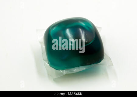 blue gel caps in hand for washing mashine, liquid coloured detergent ...