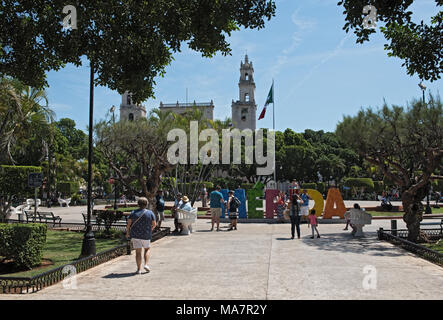 Merida Sign, Mexican flag, Plaza Grande, Cathedral de IIdefonso in the ...