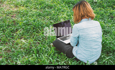 Young student relax in the park. work with laptop in green grass Stock ...