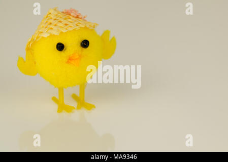 Yellow Easter chick on a reflective white with painted eggs out of ...