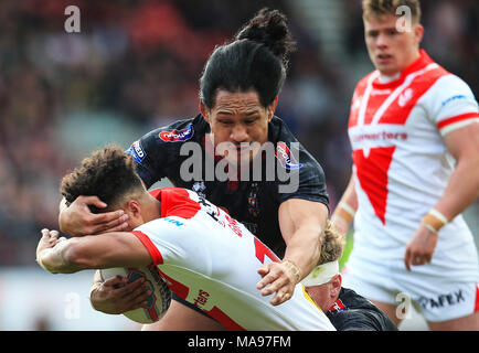 Wigan Warriors' Taulima Tautai tackles St Helens' Regan Grace during ...