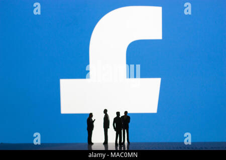 Facebook logo with models of people in foreground Stock Photo - Alamy