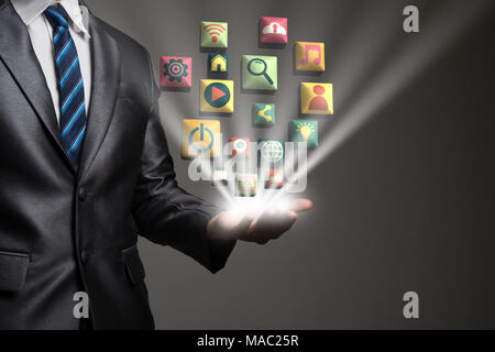 Businessman holding digital icons Stock Photo - Alamy