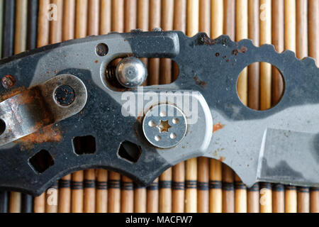 Small jackknife on a wooden background, top view Stock Photo - Alamy