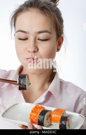 young woman with sushi on white background Stock Photo - Alamy