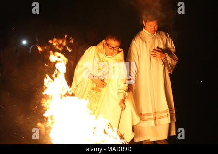 A Catholic priest lights a Paschal candle inside the Church of the ...
