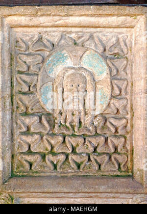 Detail of the 14th century font. St John the Baptist's head on a Stock ...