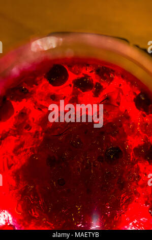 Bright translucent red currant jam in a glass jar, close-up, macro ...