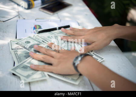 Dollars in woman's hands. Counting money Stock Photo - Alamy