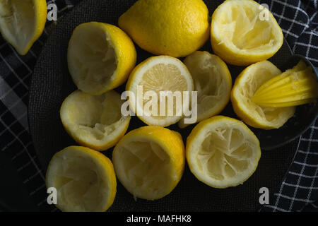 Top view of cut lemon slices in black wire bowl on black table Stock ...