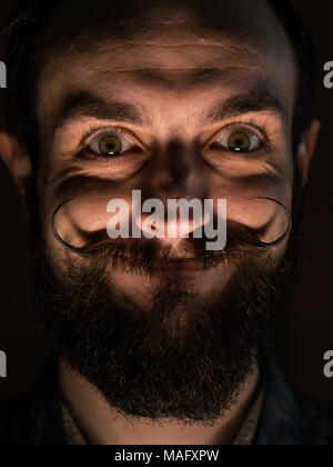 Inventor Hipster with Beard and Mustages in the Dark Room. Smiling ...