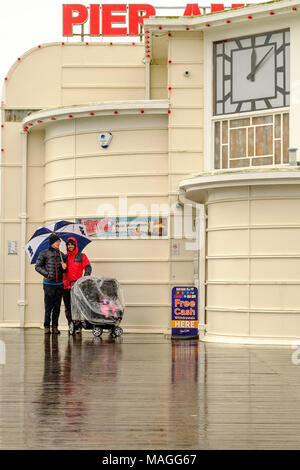 Worthing pier ammusment arcade and art deco clock in the early evening ...