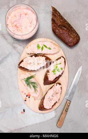 Pieces of bread with fish pate on white wooden table Stock Photo - Alamy