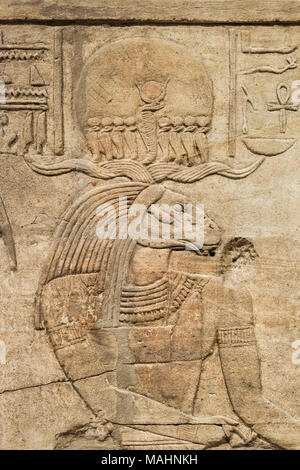 Ancient Egyptian god Amun (Amun-Ra), sitting on his throne and holding ...