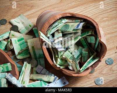 Broken money box, with Saudi Riyal banknotes and coins Stock Photo - Alamy