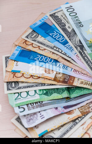 Banknotes different countries on the wooden table Stock Photo - Alamy