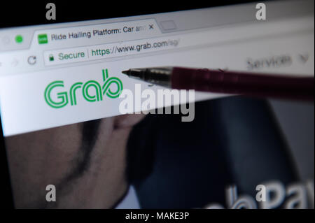 Grab, the ride hailing company website on a computer screen Stock Photo ...