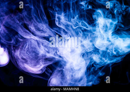 Dense multicolored smoke of blue and purple colors on a black isolated ...