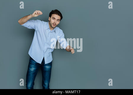 Delighted nice man moving his hands Stock Photo - Alamy