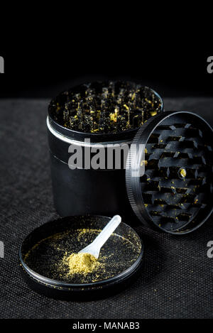 A medicinal marijuana grinder with keef and scraper. Black background ...