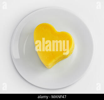 White flour heart shape on rustic wooden table with baking ingredients ...