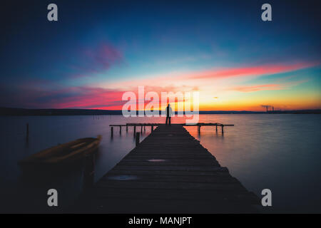 colorful sunset over the sea lake with dark red clouds in summer Stock ...