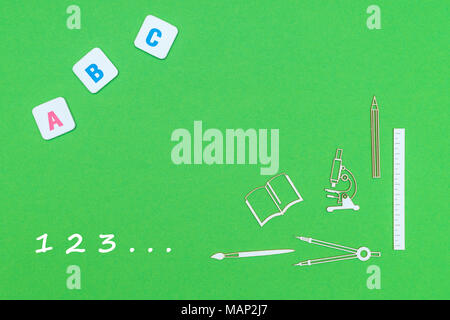 text 123, school supplies wooden miniatures on green background Stock ...
