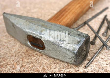 Hammer and a handful of nails are on chipboard Stock Photo - Alamy