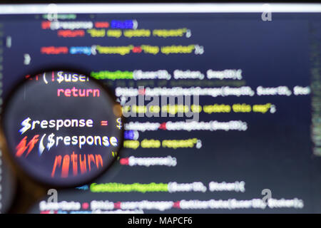 PHP back-end code zoomed through a magnifier. Computer programming source code lookup. Abstract ...