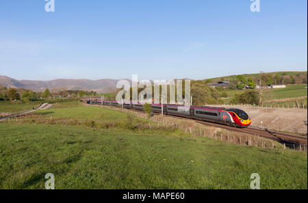 A Virgin trains Pendolino train passes Cleghorn, Lanarkshire on the ...