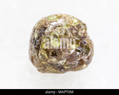 specimen of natural tumbled peridot crystal cutout on white background ...
