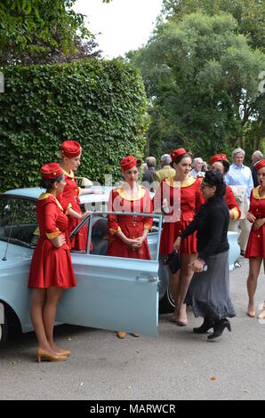 Girls in taxi cab uniforms taking part in the 2014 Goodwood Revival ...