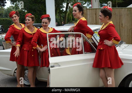 Girls in taxi cab uniforms taking part in the 2014 Goodwood Revival ...
