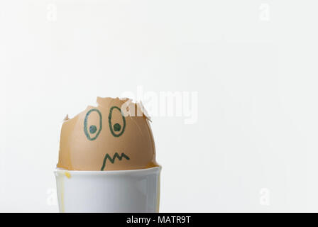 An unhappy, confused and dazed boiled egg. Copy space on right Stock ...