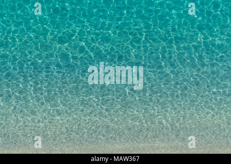 Blue sea water washing rocky shore Stock Photo - Alamy